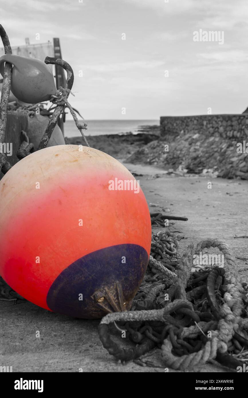 Buoy, used in the fishing industry, on the slip way of a harbour jetty ...