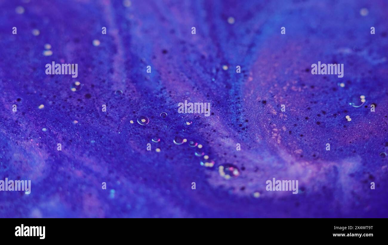 Bubble paint. Wet ink. Glitter water. Defocused blue purple color ...