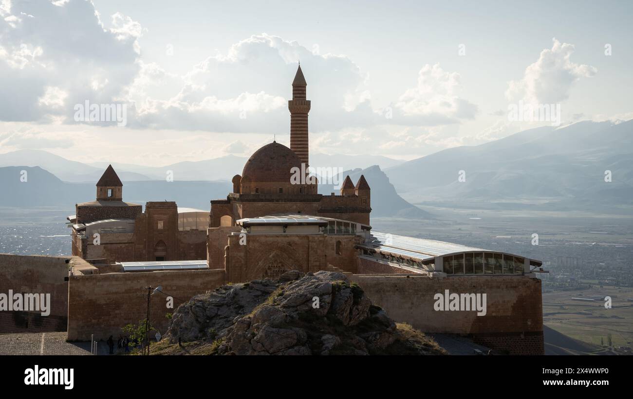 Historical Arabian palace with minarets overlooking city in the valley ...