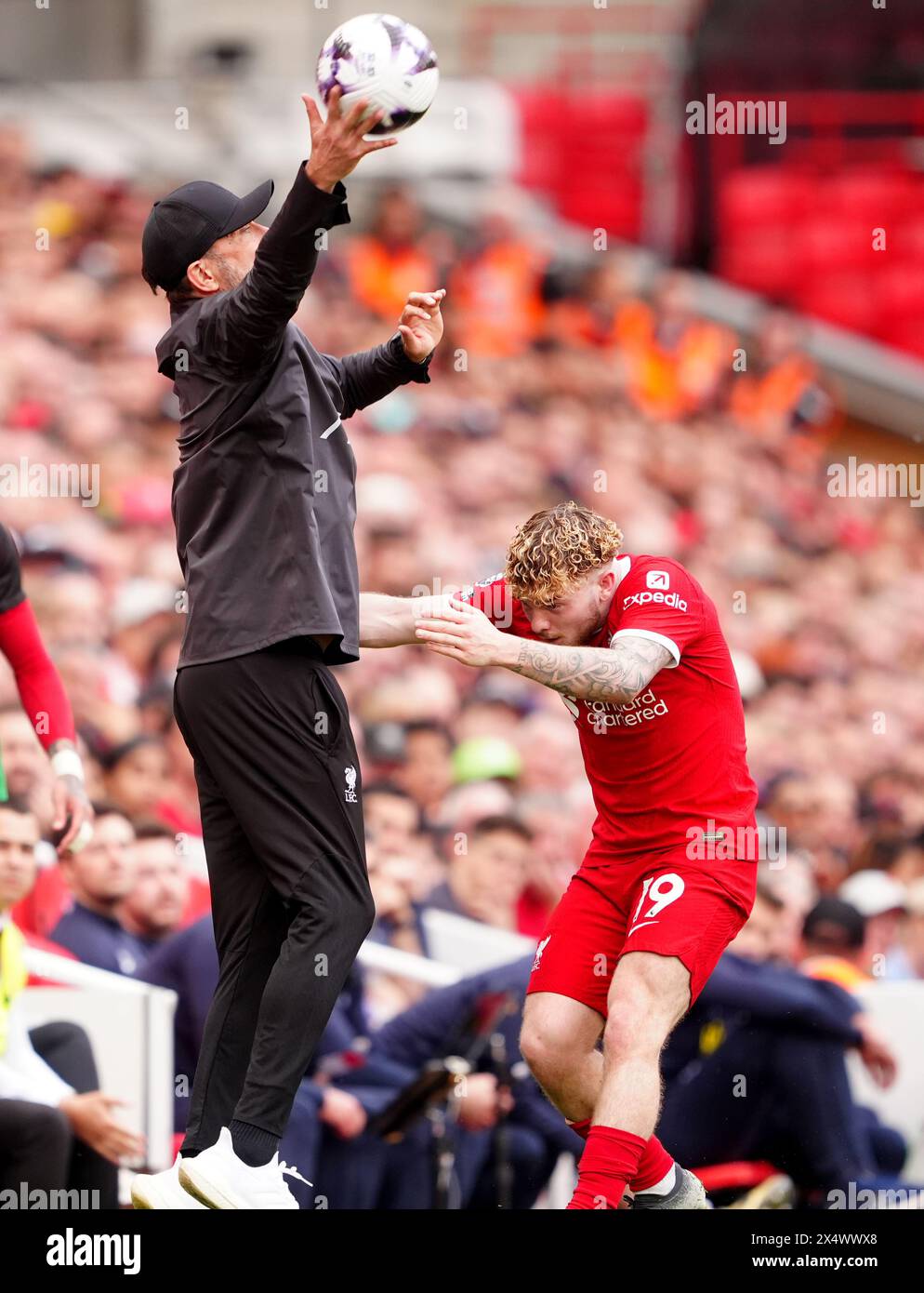 Liverpool's Harvey Elliott (right) collides with manager Jurgen Klopp ...