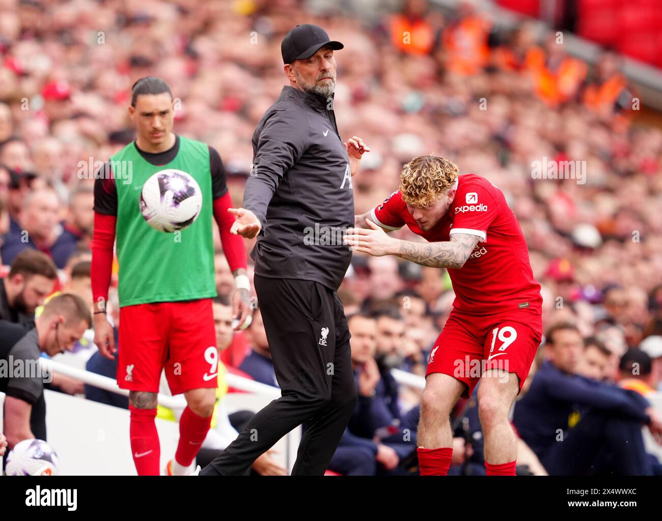 Liverpool's Harvey Elliott (right) collides with manager Jurgen Klopp ...
