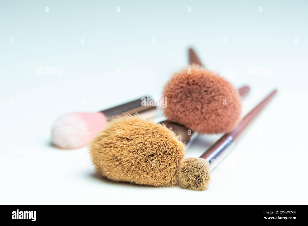Composition of four makeup application brushes of different sizes and ...