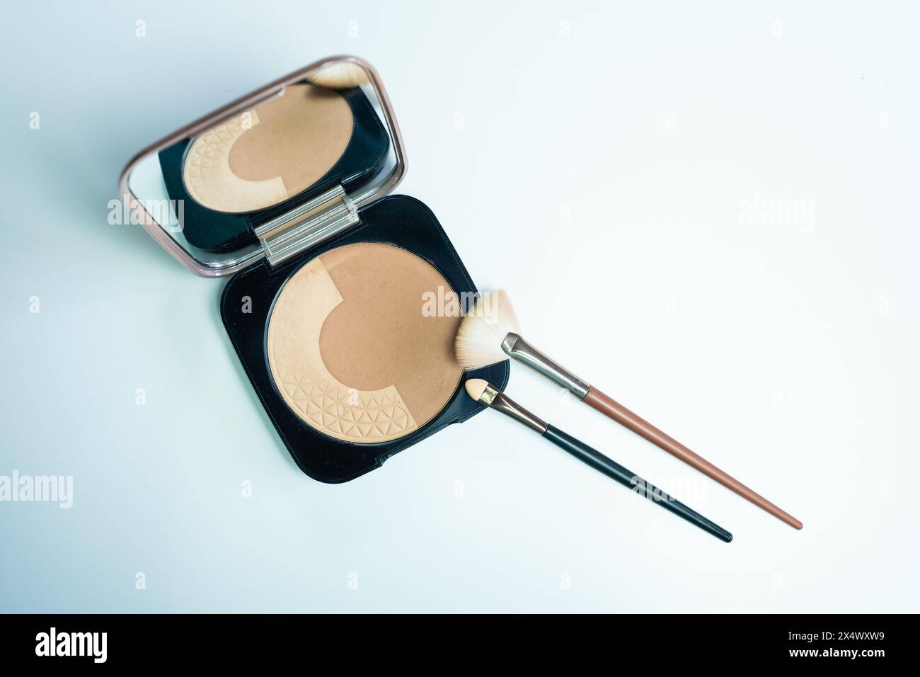 Top view of a small makeup kit with bronzing powders and two different ...