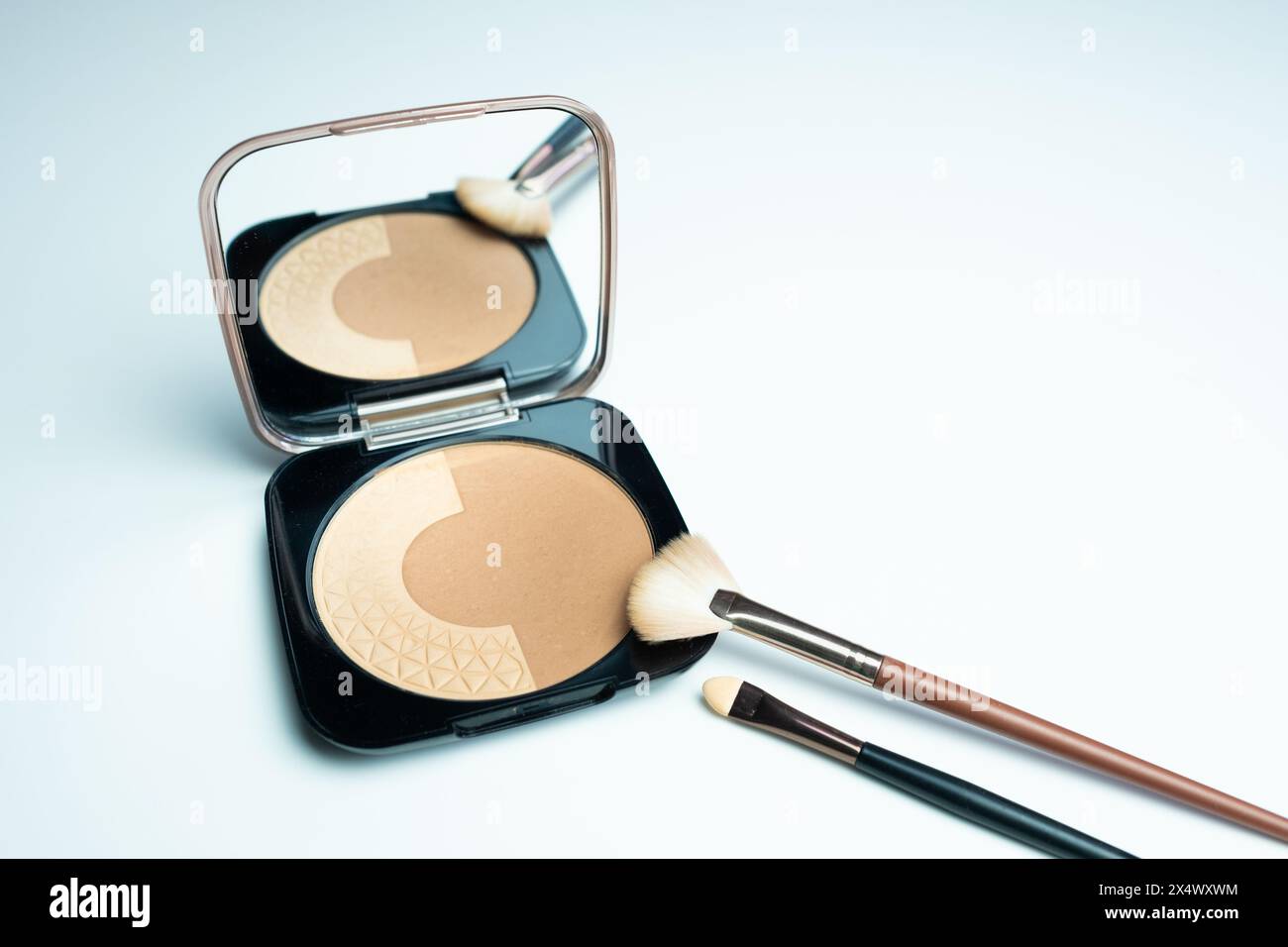 A small makeup kit with bronzing powders and two different types of ...