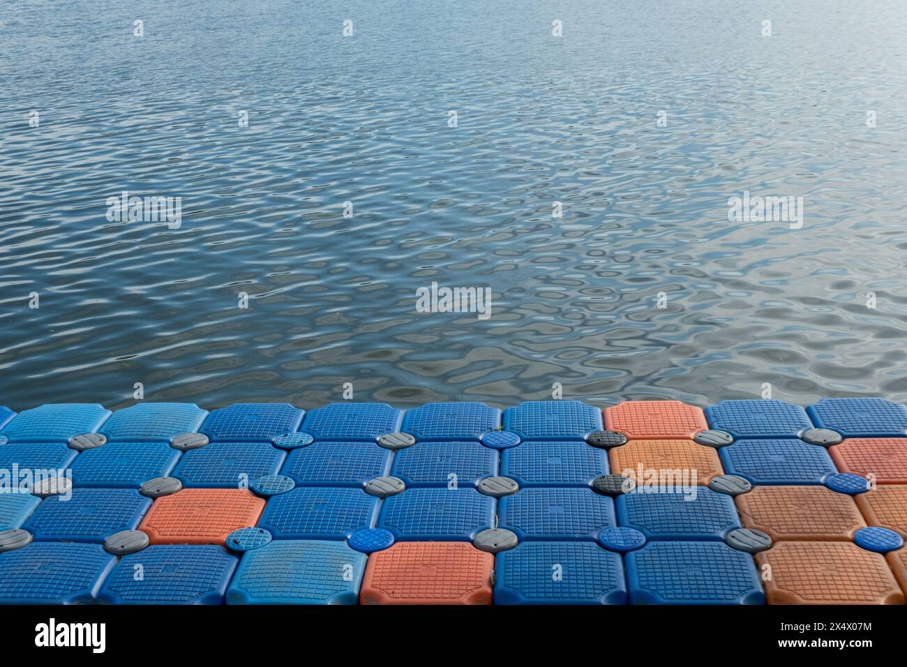 Floating pier made of composite plastic blocks on the river, sea ...