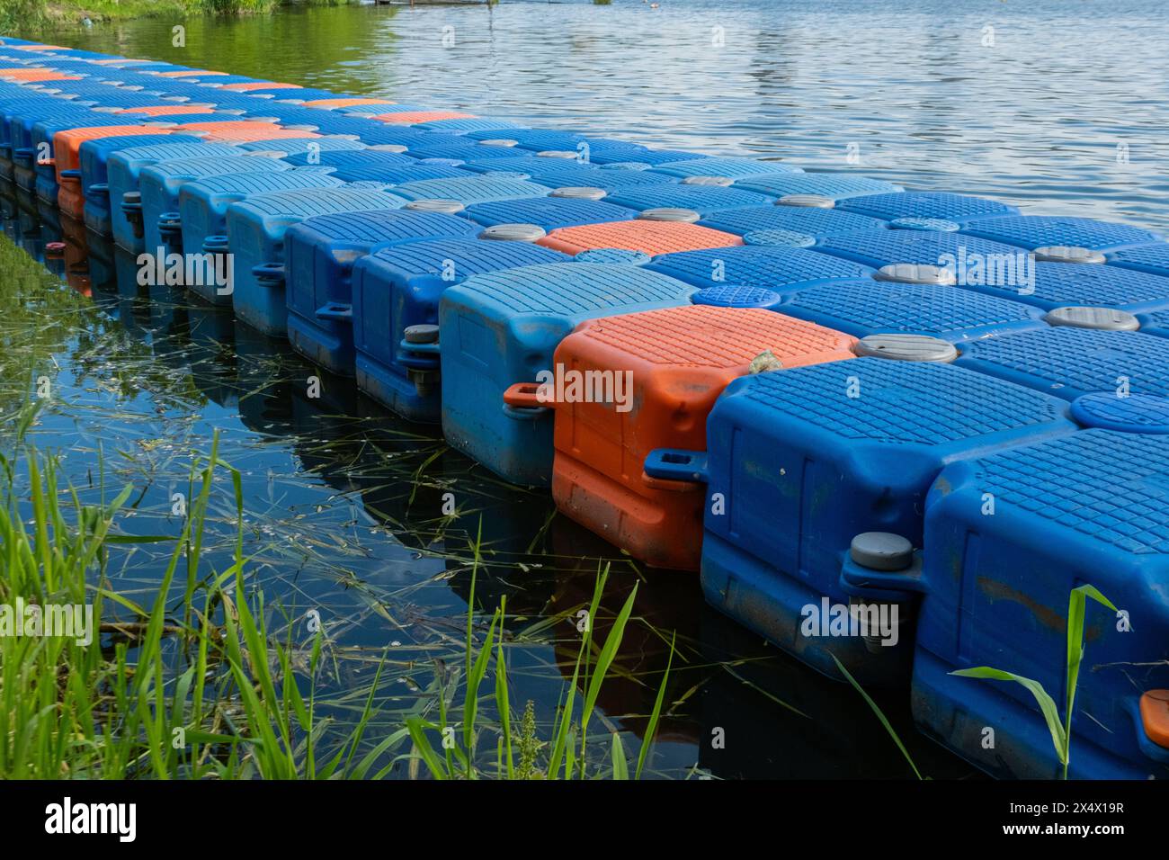 Floating pier made of composite plastic blocks on the river, sea ...