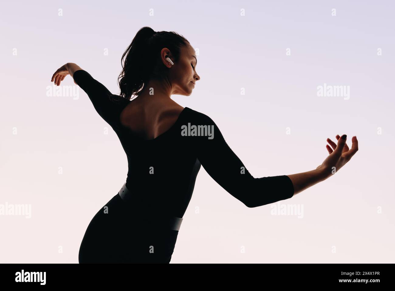 Confident, young female dancer showcases artistic expression with ...