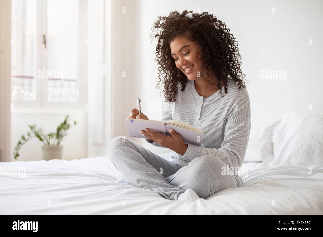 Woman bed notebook hi-res stock photography and images - Alamy