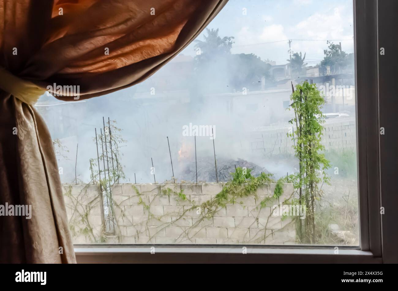 Window View of a Small Fire Stock Photo - Alamy