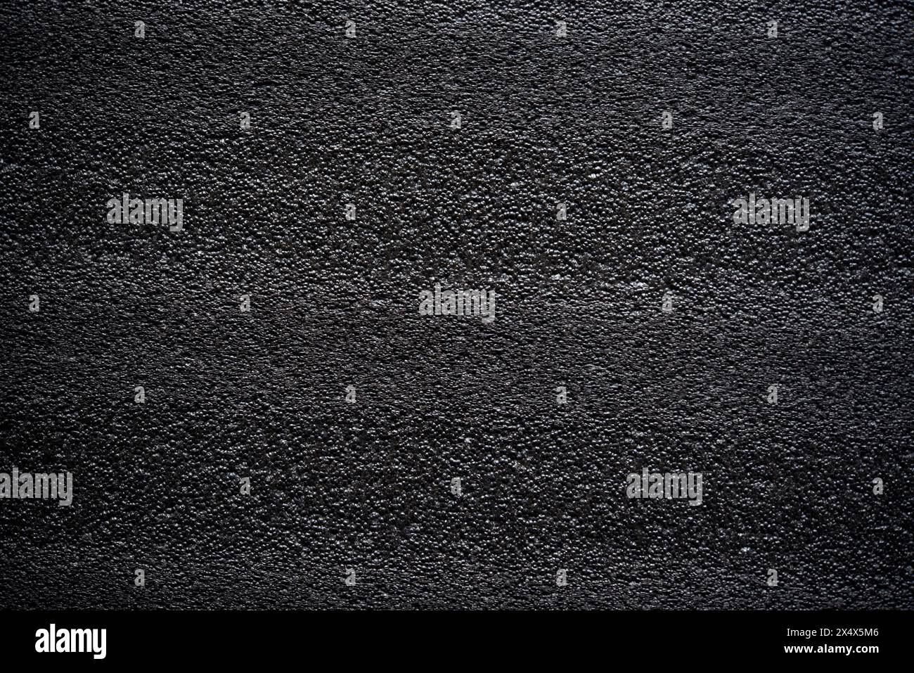 Black porous porous foam background. Background texture of black foam ...