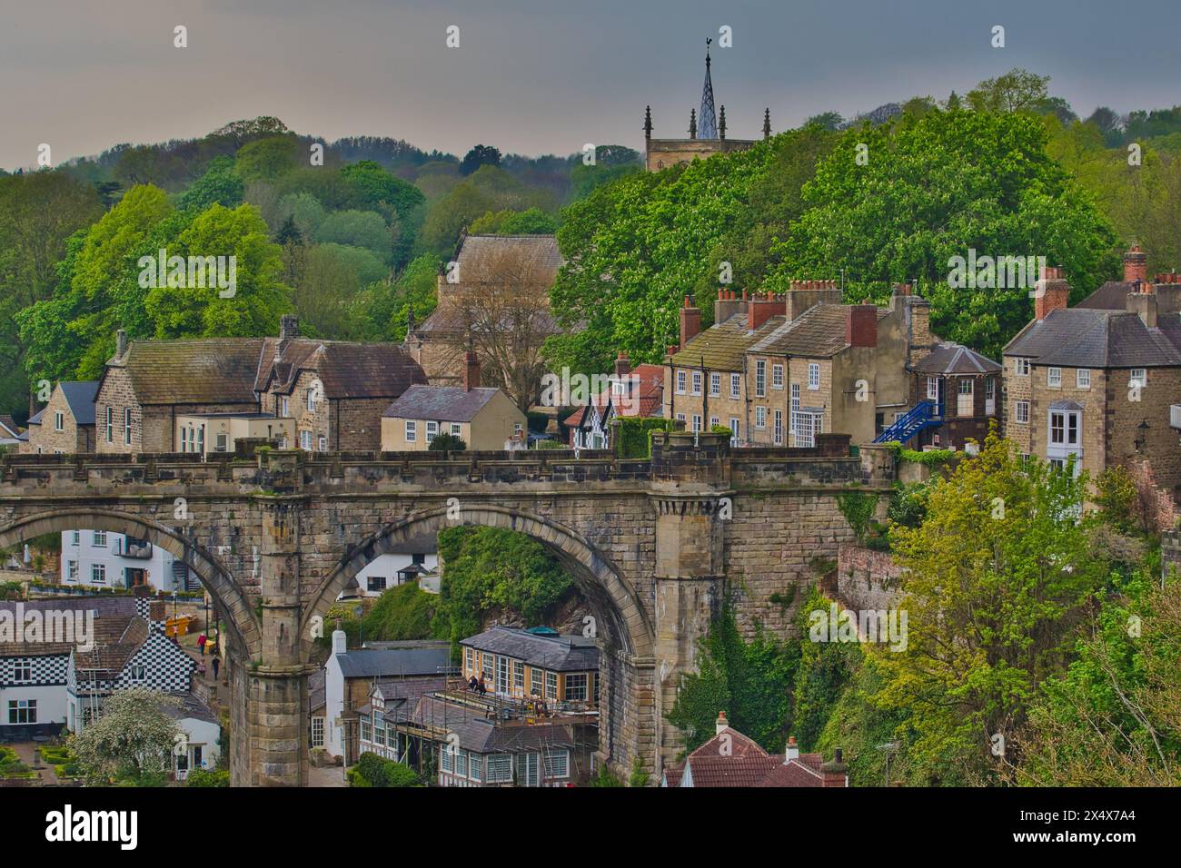 Picturesque view of a historic village with an old stone bridge ...