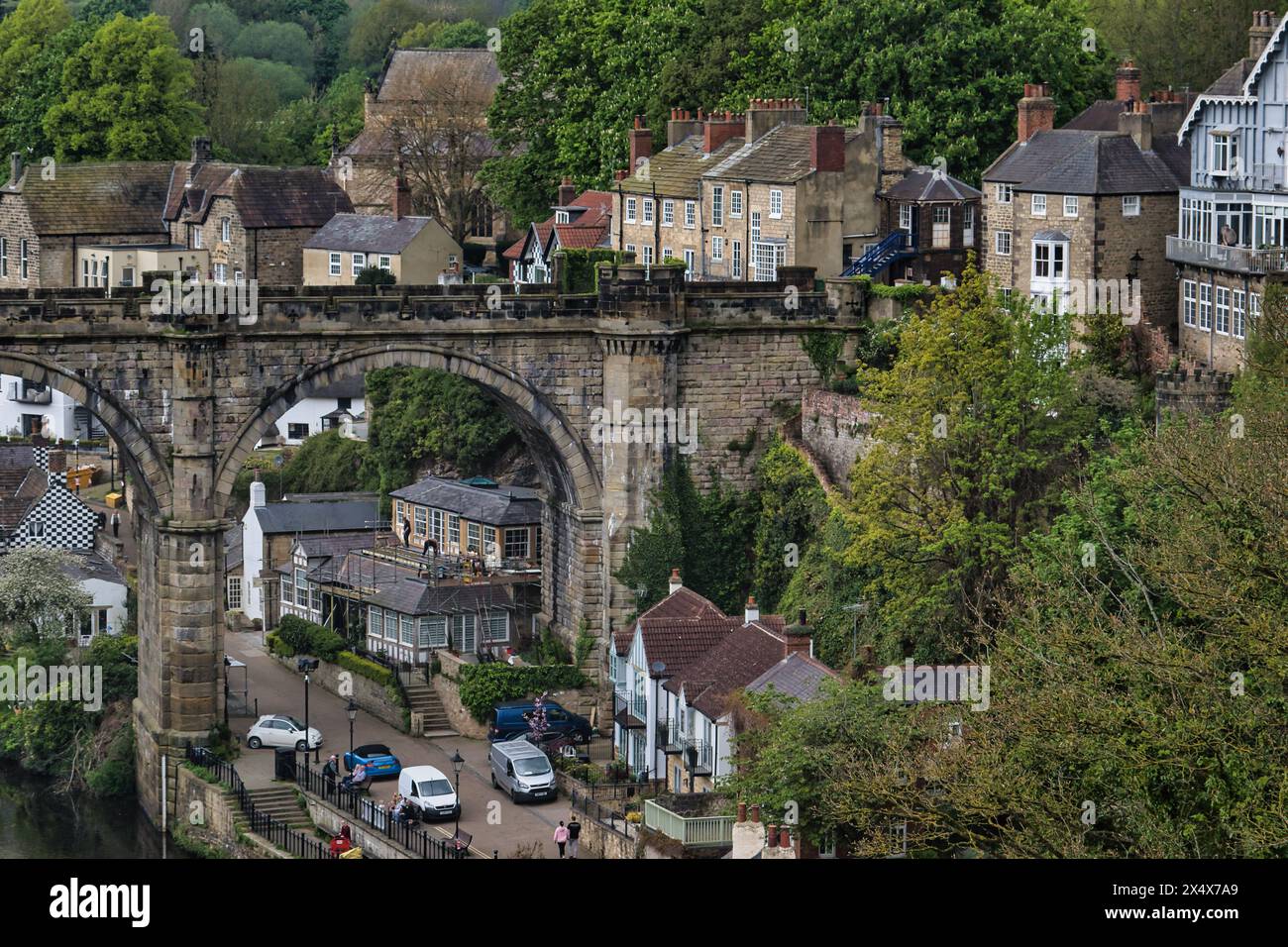 A picturesque view of a historic town with an old stone bridge arching ...