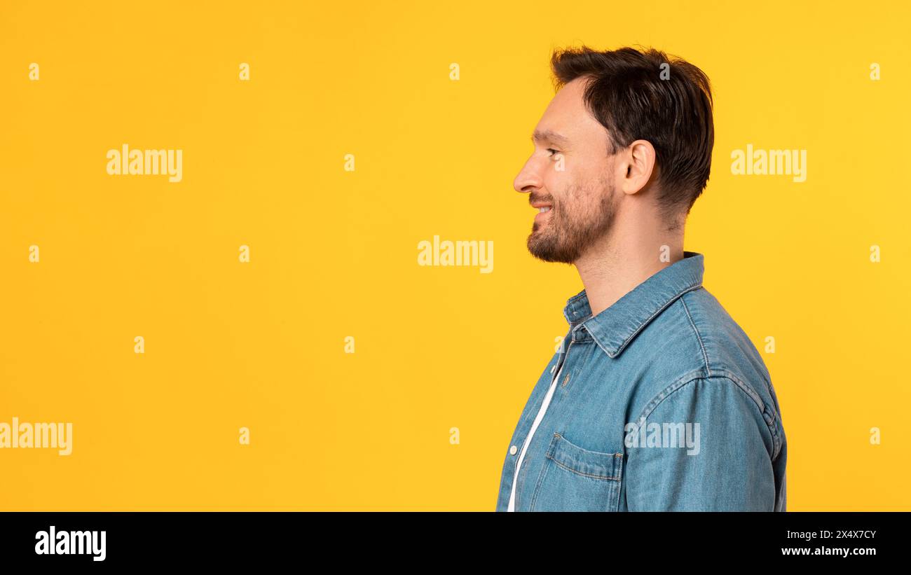 Man Standing in Front of Yellow Background, Blank Space Stock Photo - Alamy