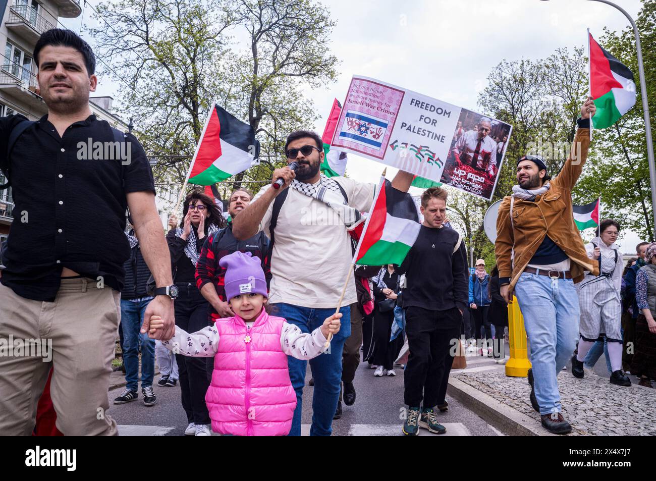Participants march with flags during the demonstration. As April began ...