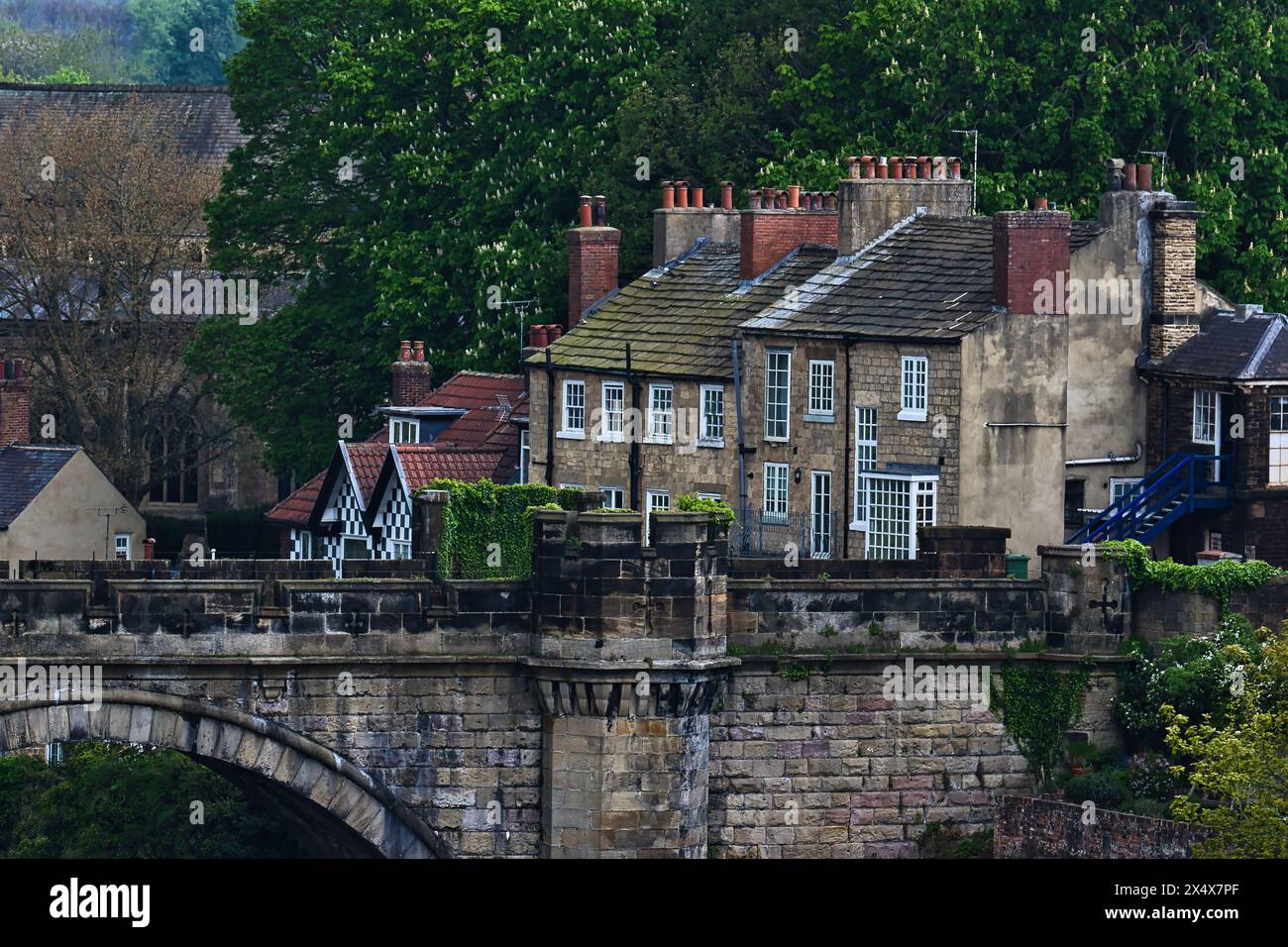 Historic stone bridge with charming old houses on top, surrounded by ...