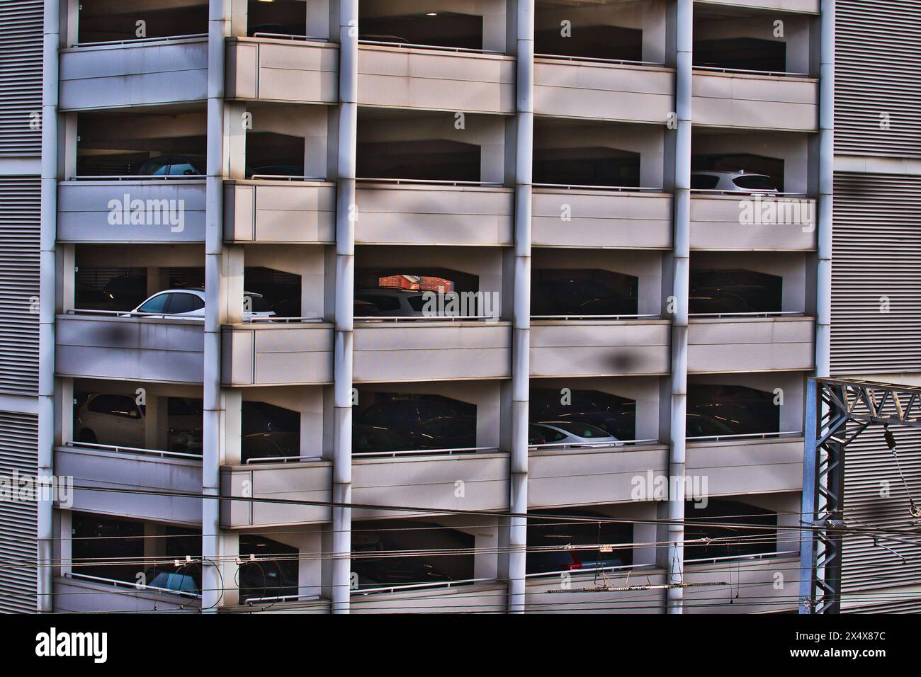 A multi-level parking garage filled with cars, showcasing a modern urban infrastructure for ...