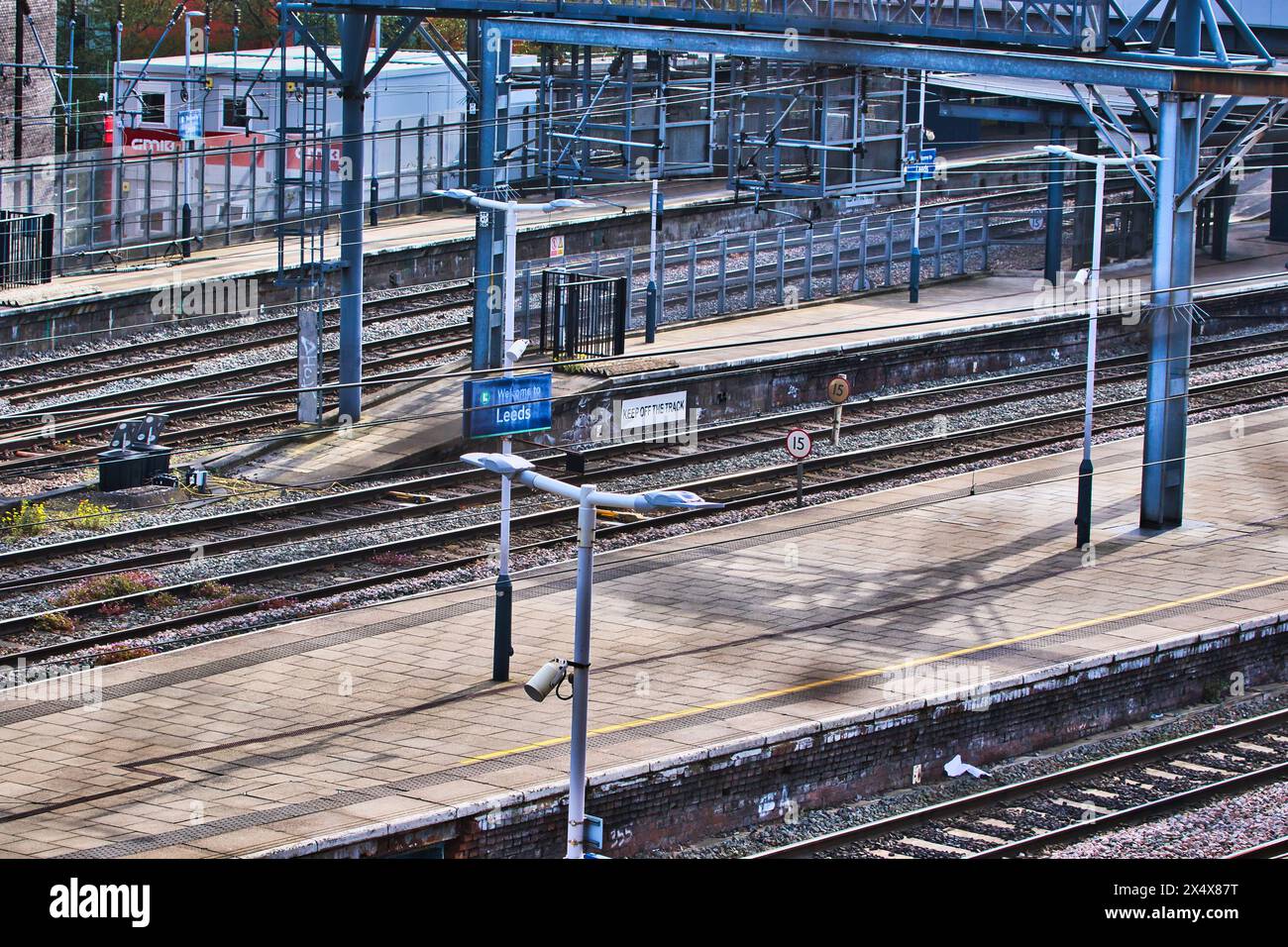 A detailed view of a railway station with multiple tracks and platforms ...