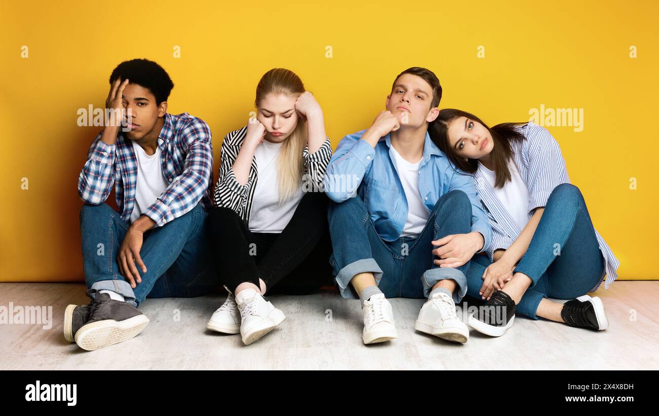 Young Friends Sitting Together Looking Tired and Bored Stock Photo - Alamy