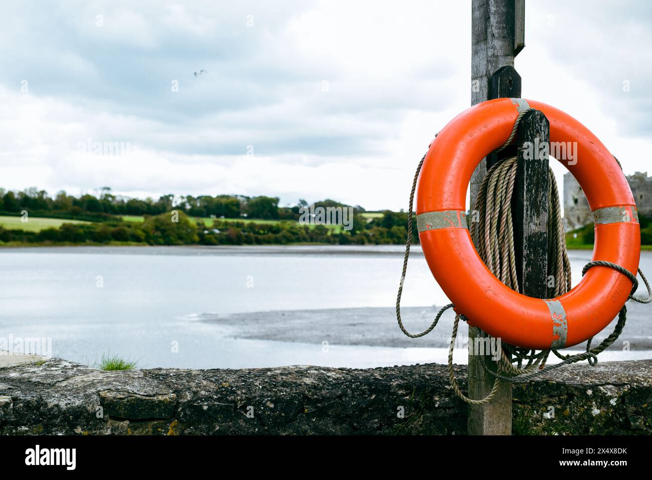 Orange Lifebuoy in round life ring shape used in emergency to save people from drowing in water ...