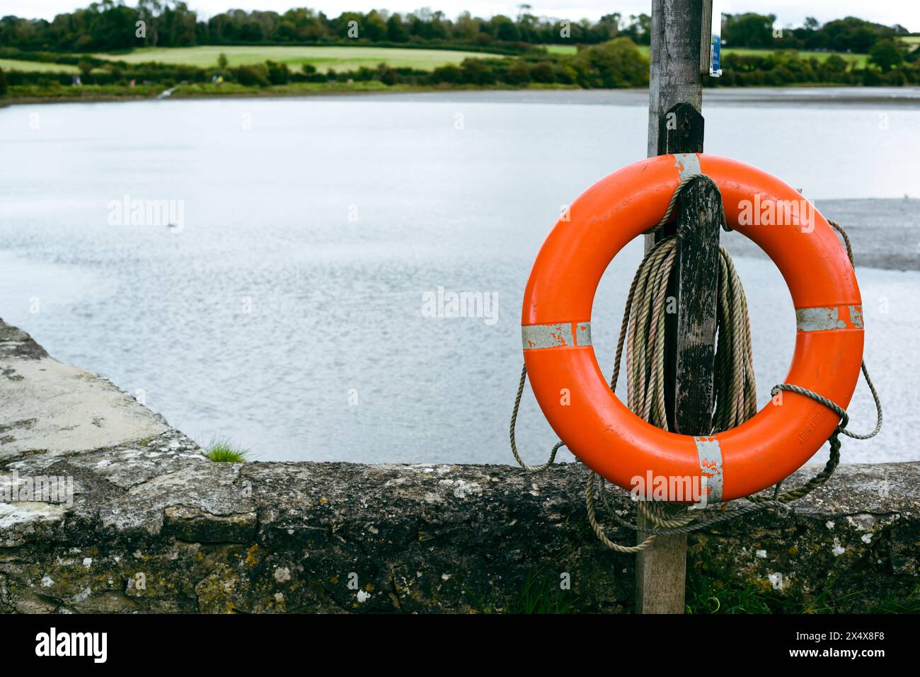 Orange Lifebuoy in round life ring shape used in emergency to save people from drowing in water ...