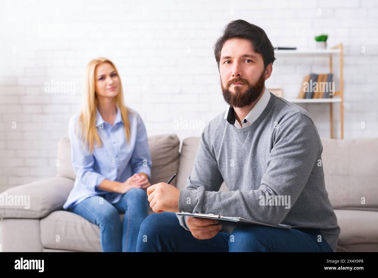 Confident psychologist looking straight at camera in cabinet Stock ...