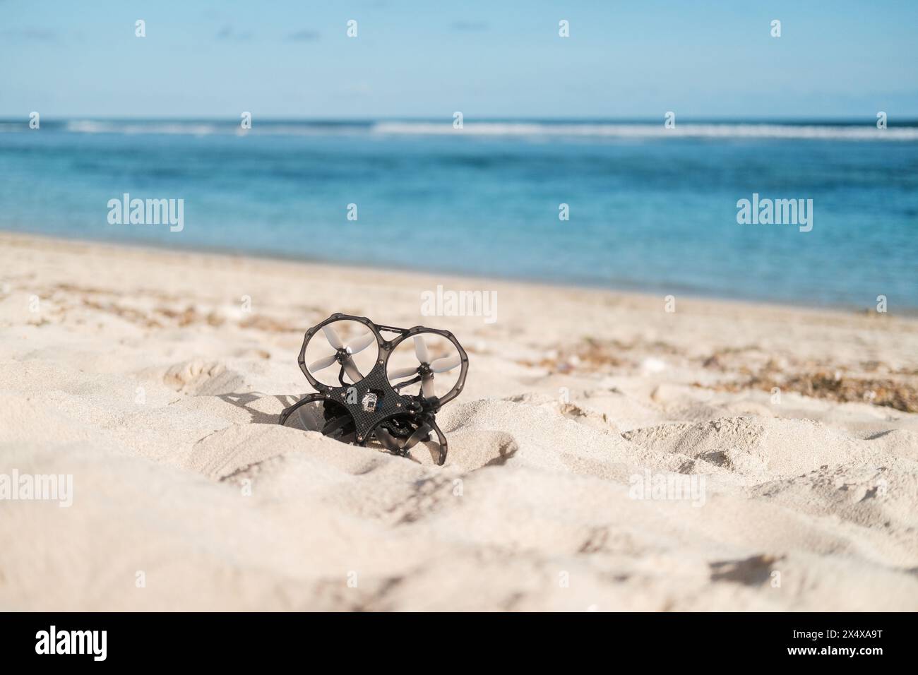 On the beach FPV drone lying on the sand, which lost its signal and ...