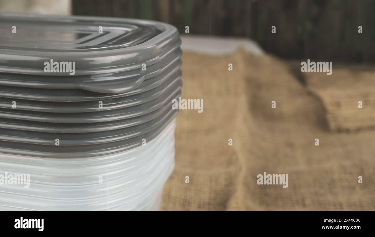 A stack of plastic food containers on the right with coipy space on the ...