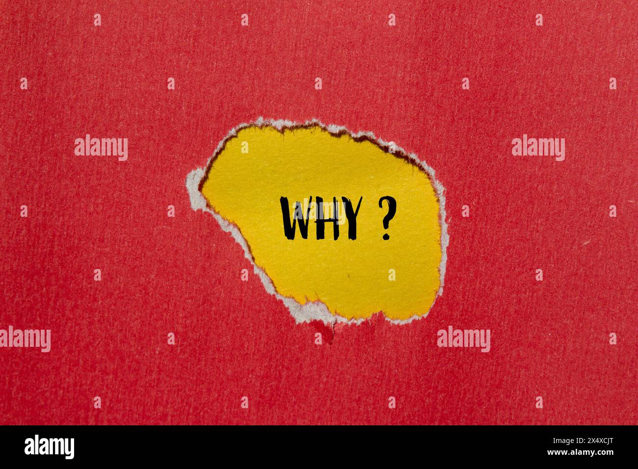Why ? question written on ripped red paper with yellow background ...