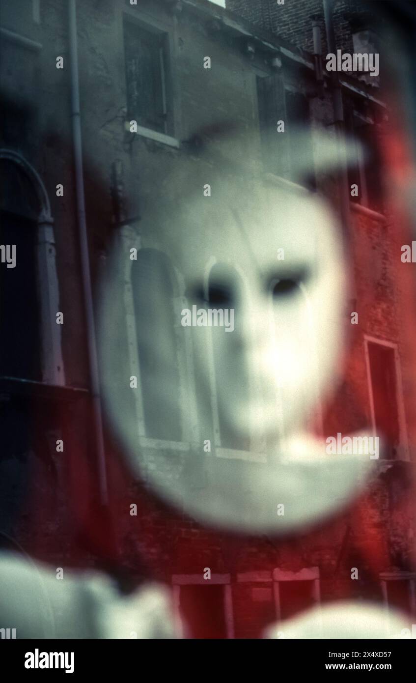 A 1990s archive photograph of reflections in the window of Ca' Macana ...