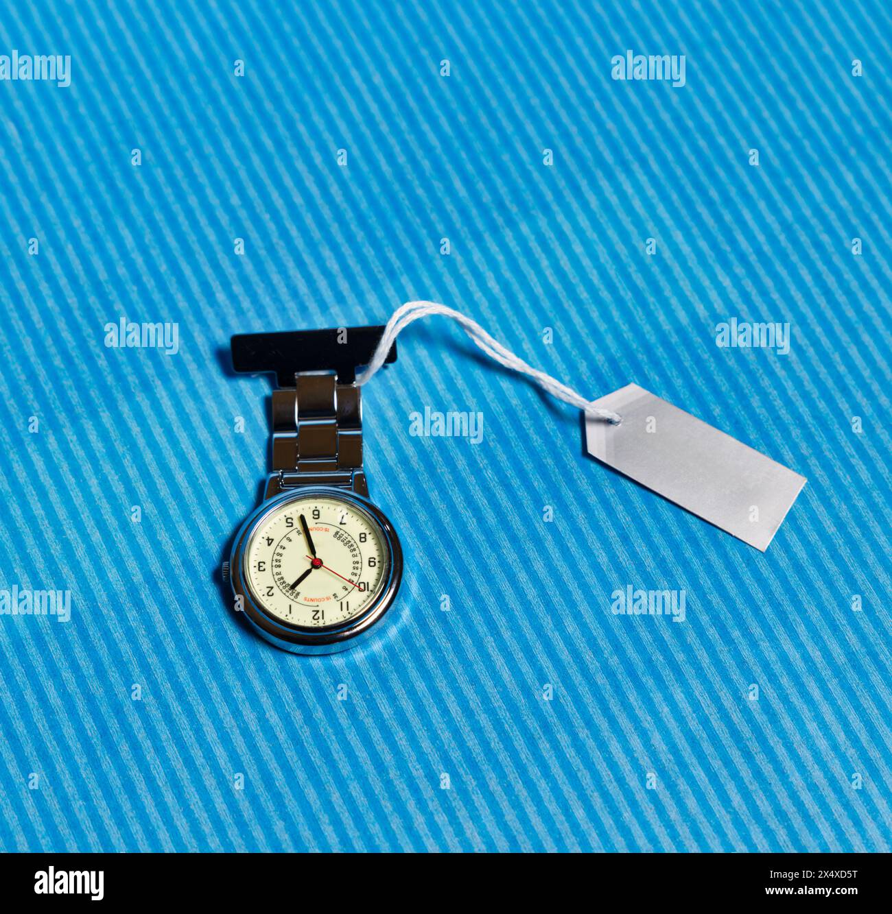 nurse watch FOB with label, studio shot on blue stripes background ...