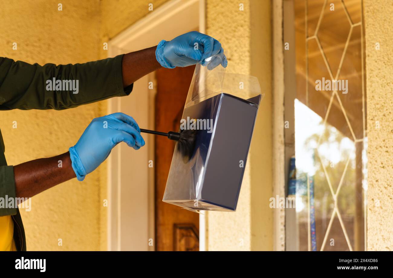 african american police detective collecting forensic evidence for ...