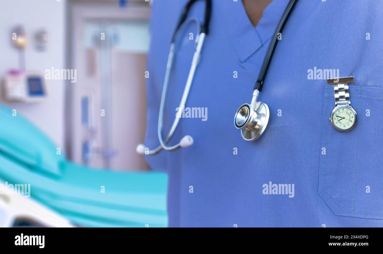 nurse in scrubs, wearing nurse watch FOB and stethoscope , hospital ...