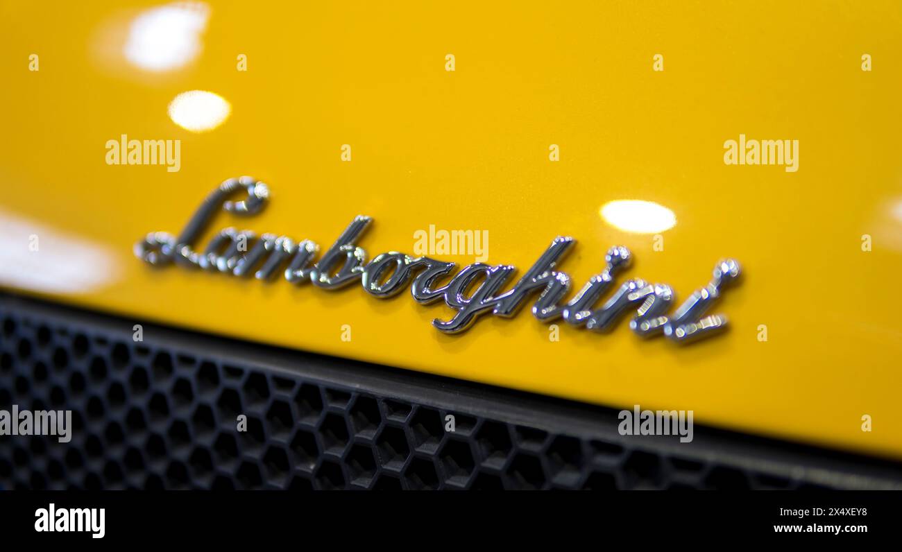 Detail of Lamborghini text on a yellow hood of a car Stock Photo - Alamy