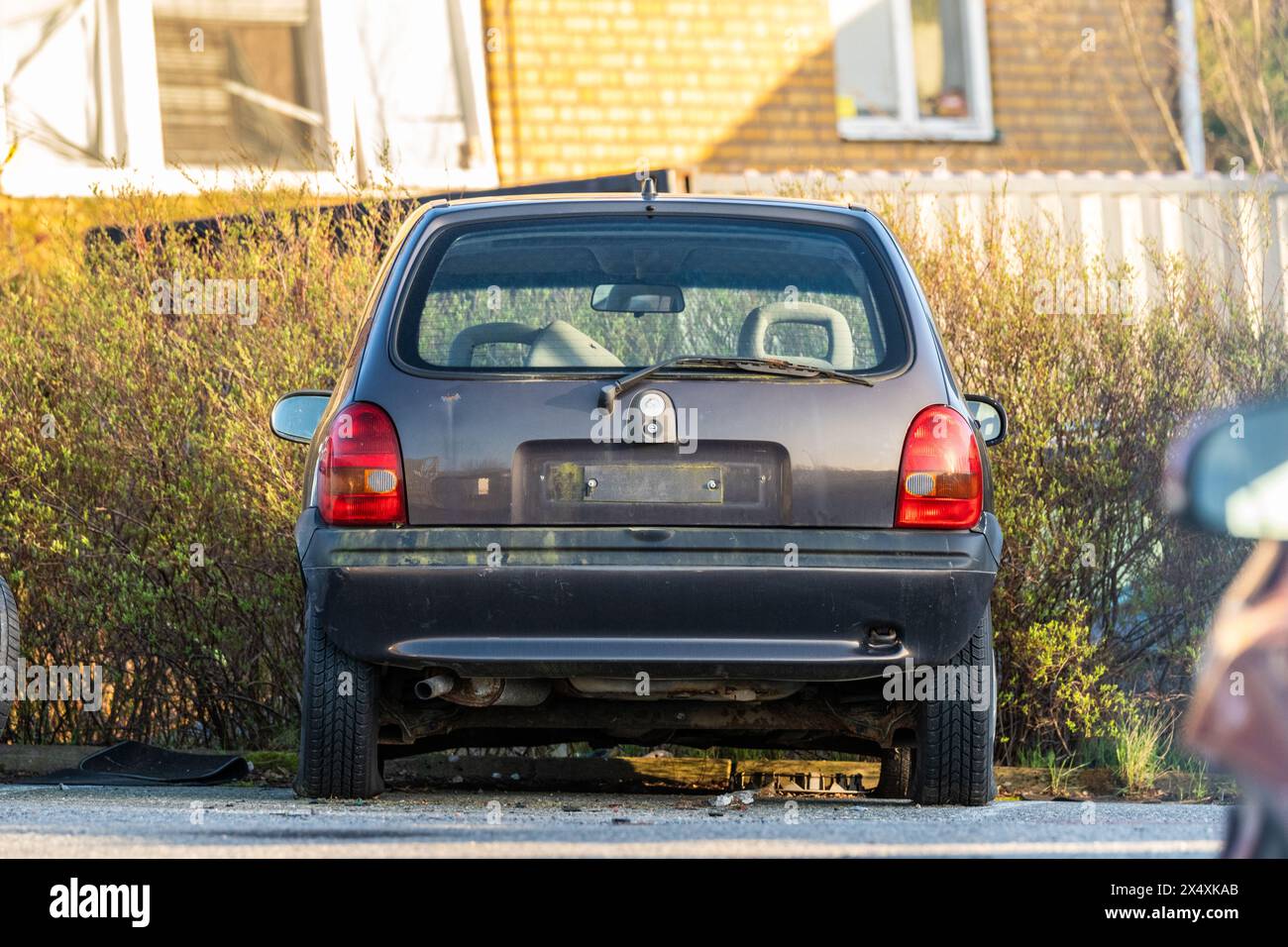 Old and damaged grey car in a parking lot Stock Photo - Alamy