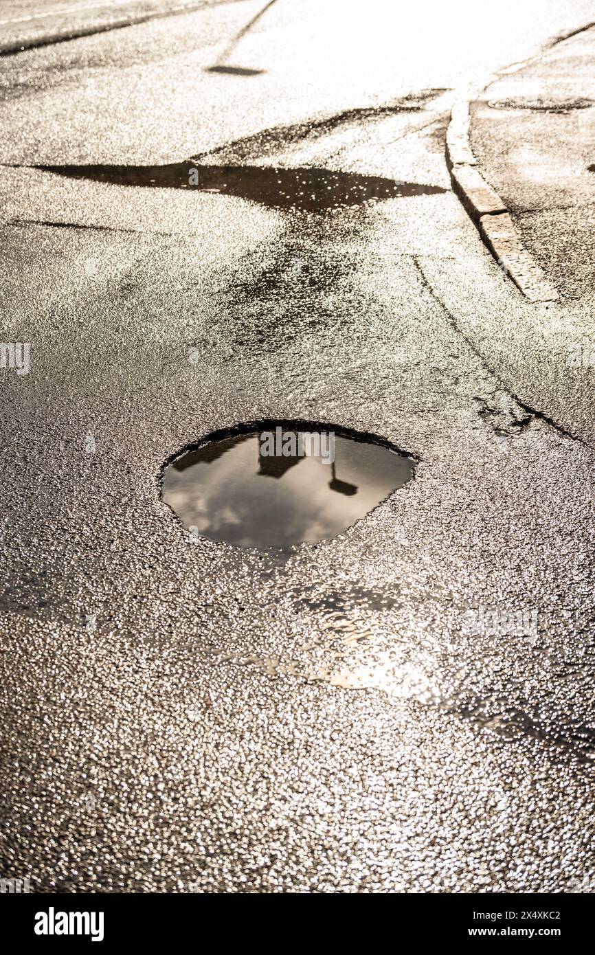 Deep pot hole in a road crossing waiting for repair Stock Photo - Alamy