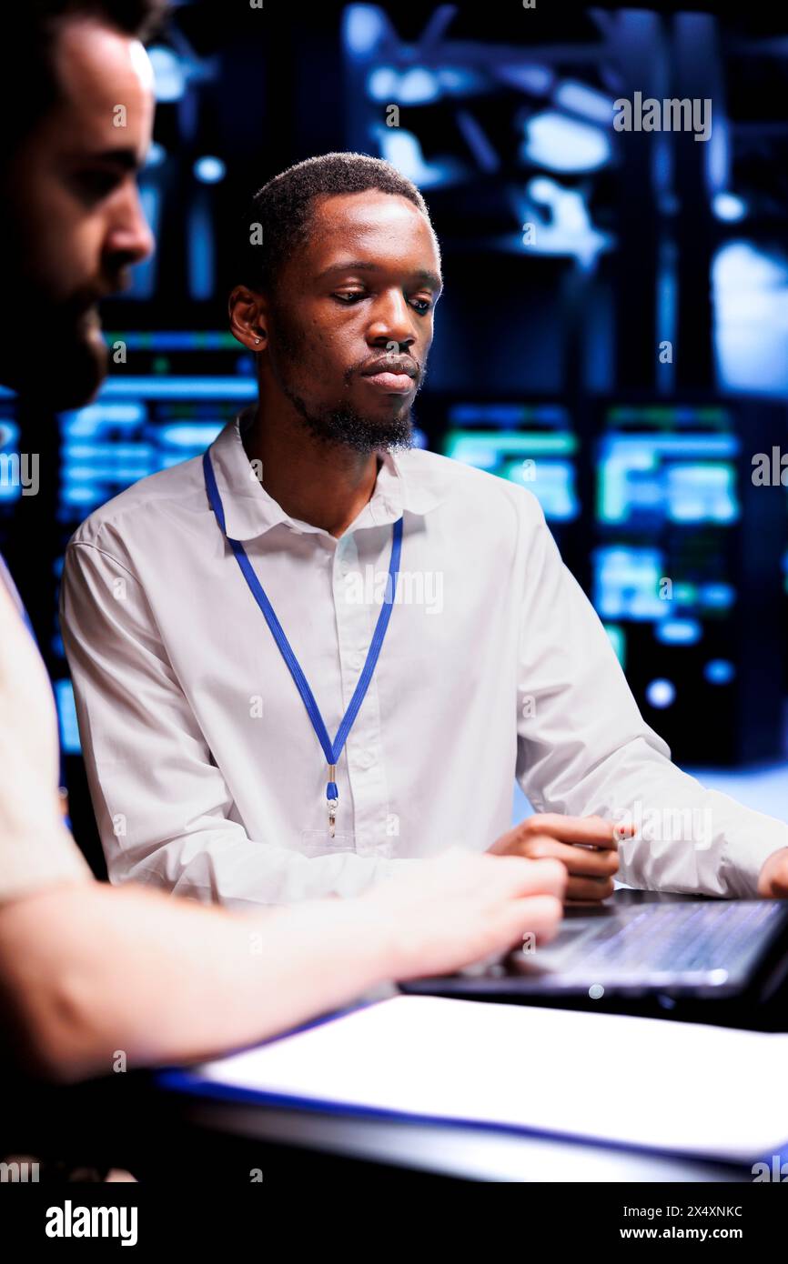 African american admin and coworker dealing with server farm system ...