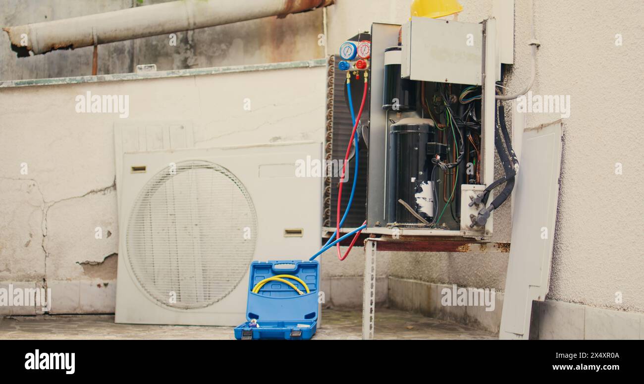 Handheld camera shot of damaged air cooling unit in need of fixing ...