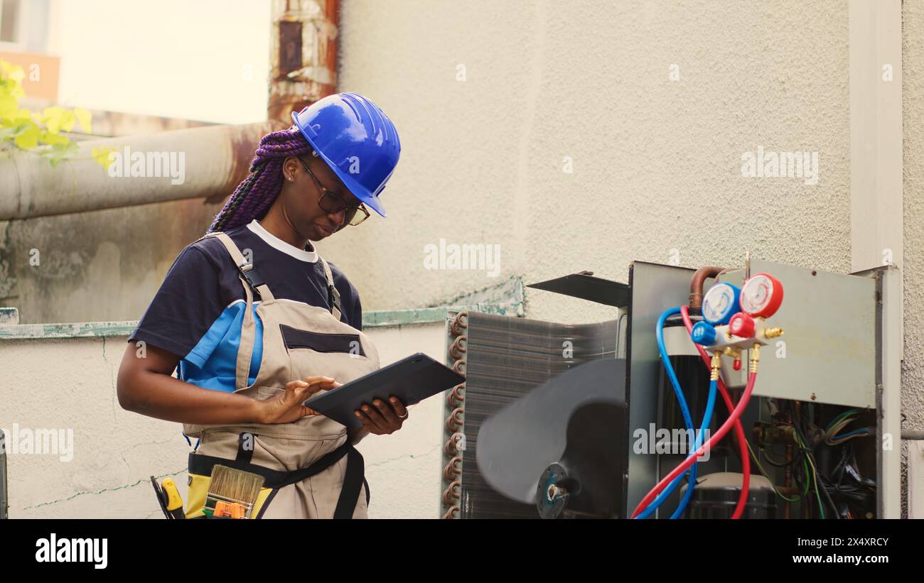 Seasoned mechanic servicing external condenser internal parts, checking ...