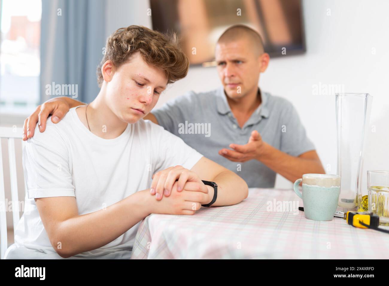 Father comforting his son Stock Photo - Alamy