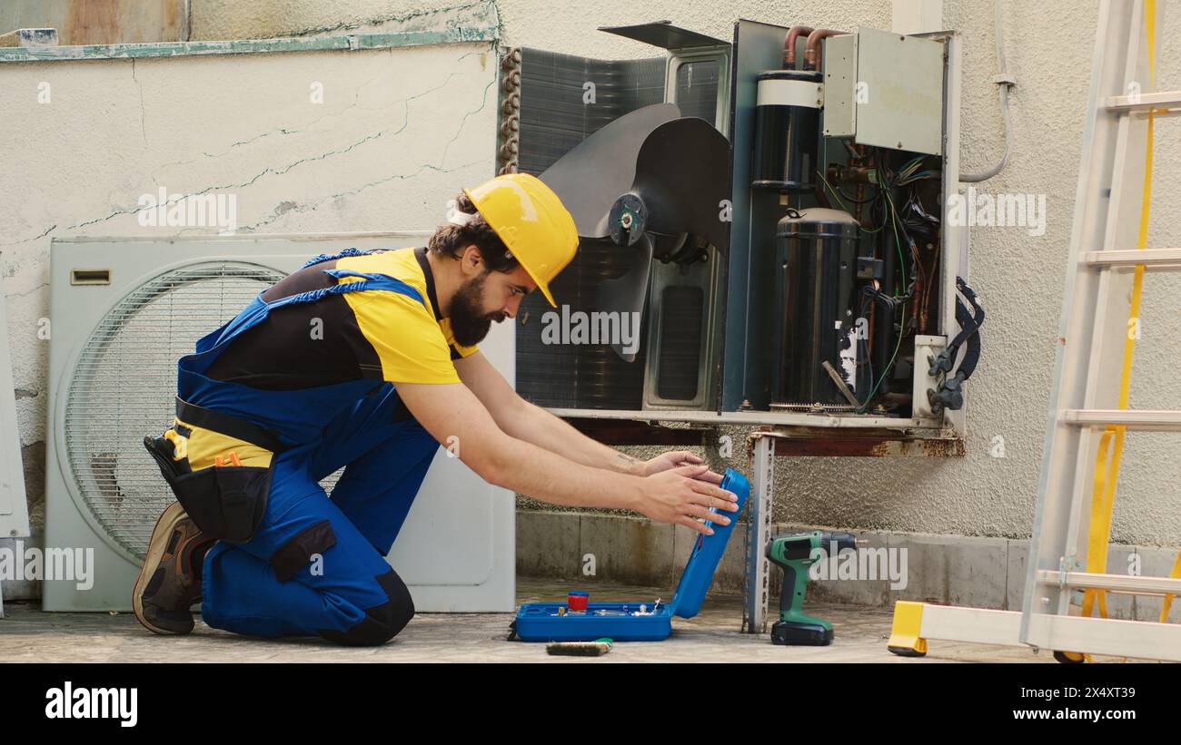 Skilled engineer commissioned for routine hvac system maintenance ...