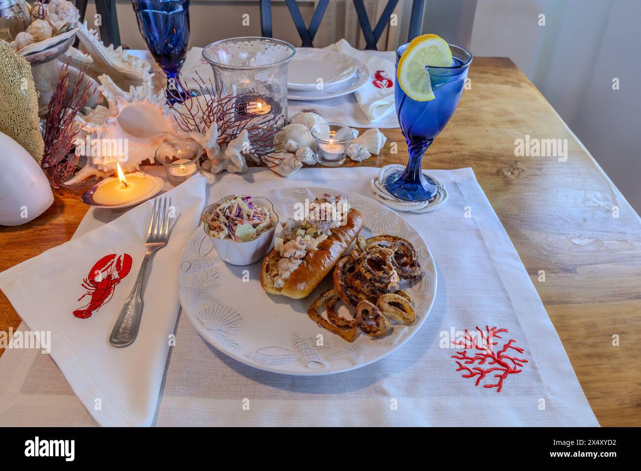 Lobster salad in a fresh brioche roll with homemade fried onion rings ...