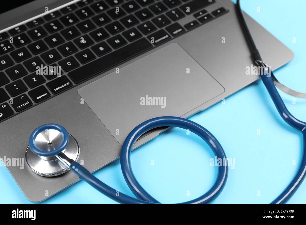Laptop and stethoscope on light blue background, closeup Stock Photo ...