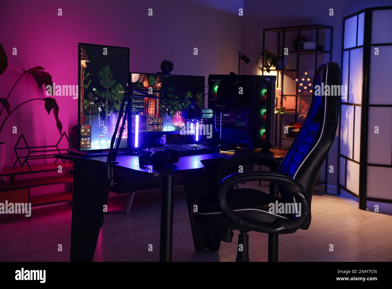 Playing video games. Stylish room interior with modern computer and ...