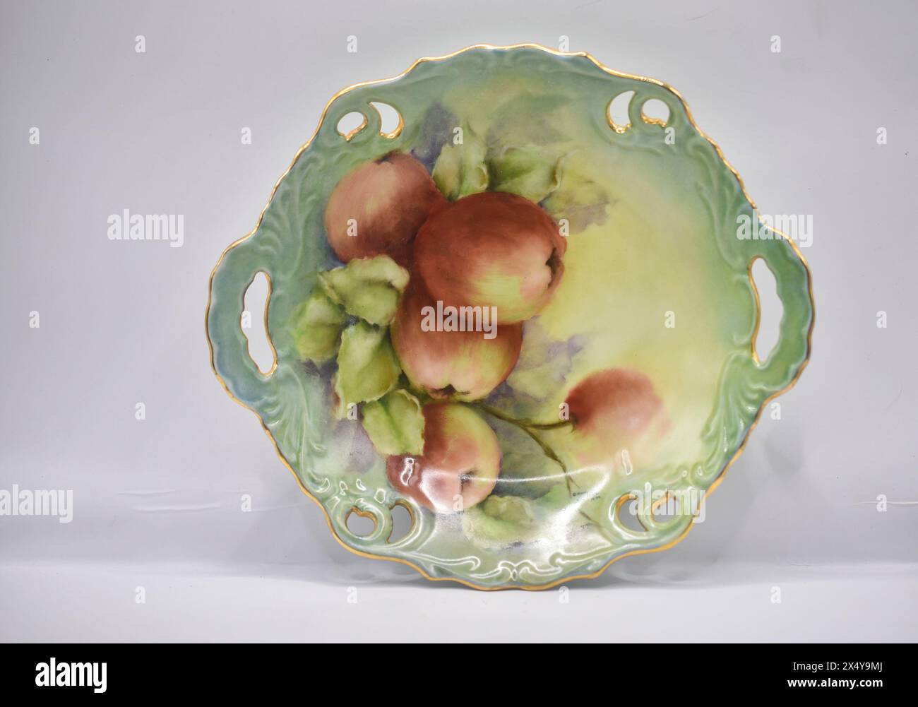 hand painted porcelain plate with apple design Stock Photo - Alamy