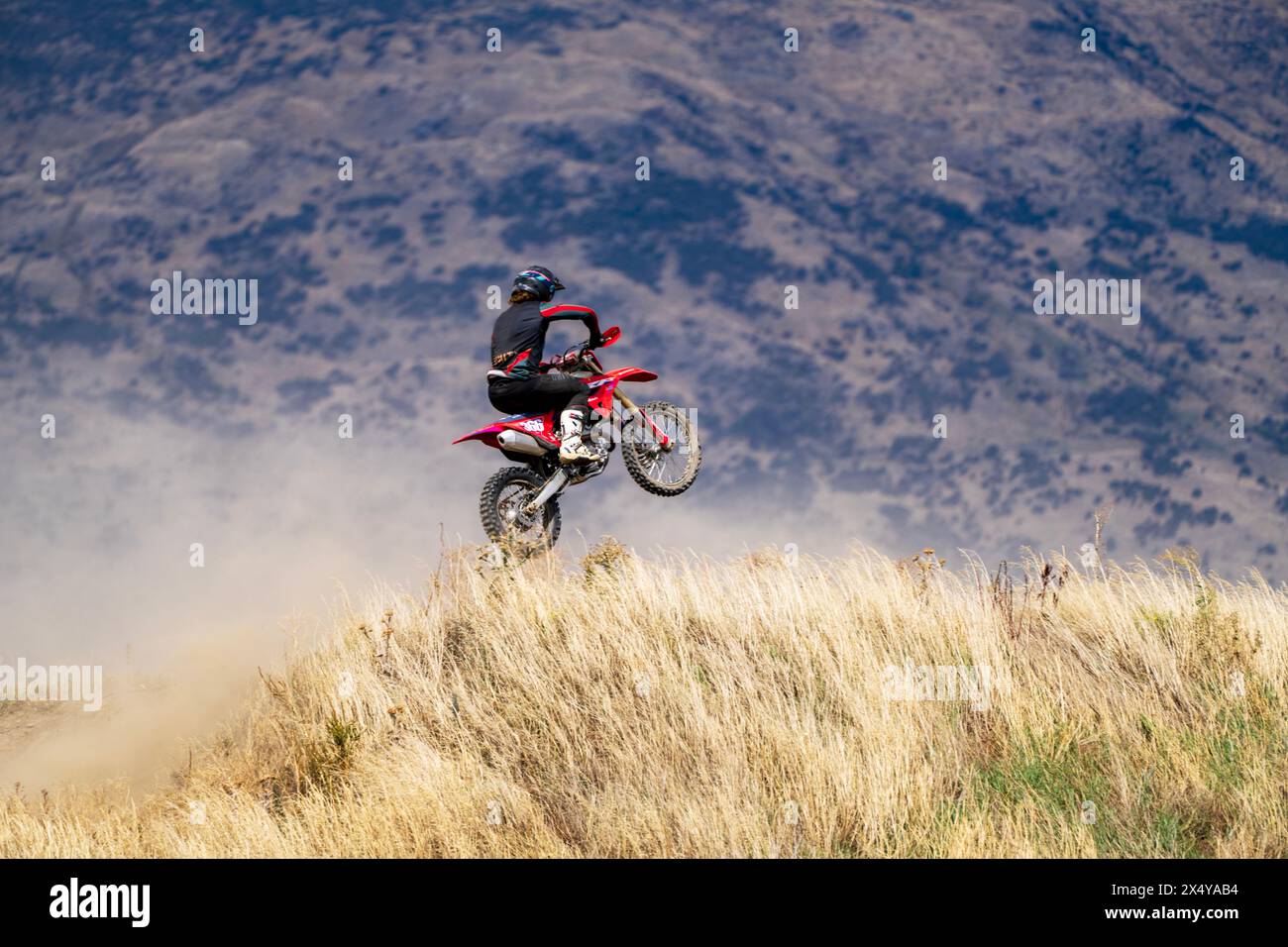 Wanaka, New Zealand - 9 February, 2024: A motocross rider in red and ...