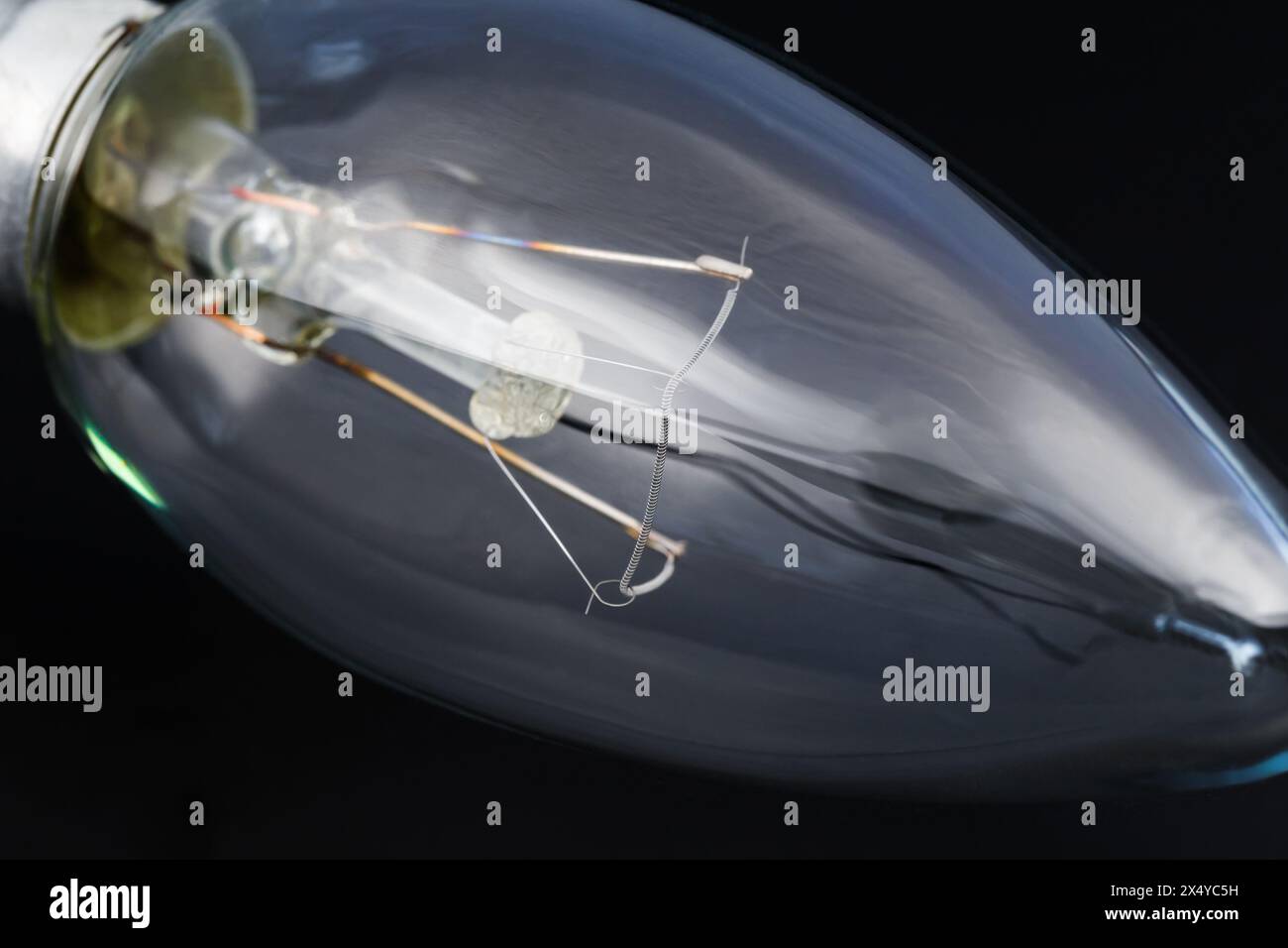 The internal structure of an incandescent lamp close-up on a dark ...