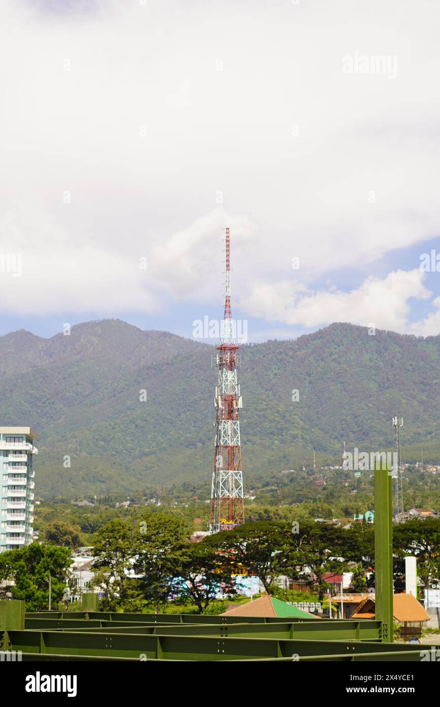 View of green hills with red signal booster towers and clear sky during ...