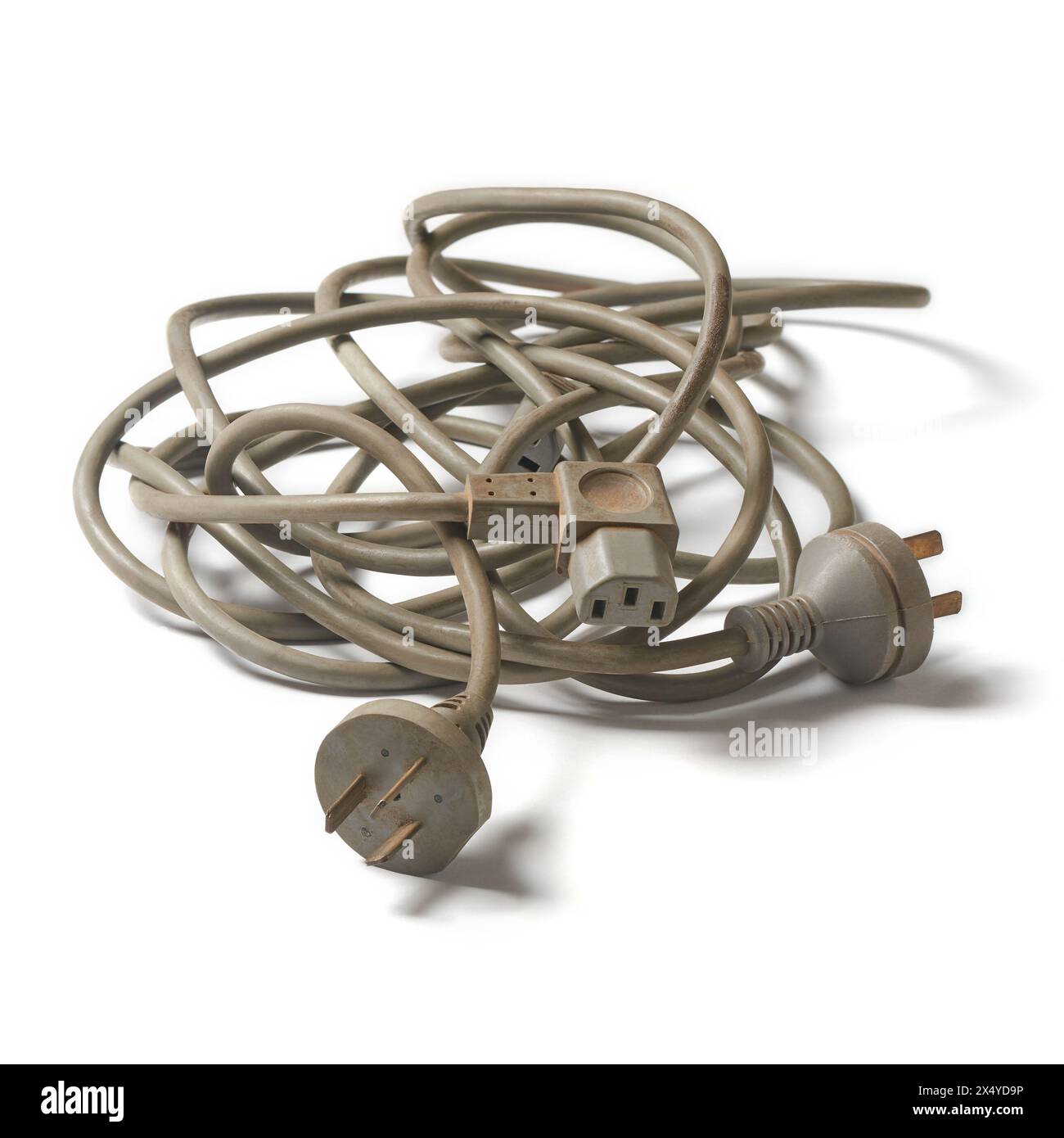 gray color old used tangled wire cord with power plug isolated white ...