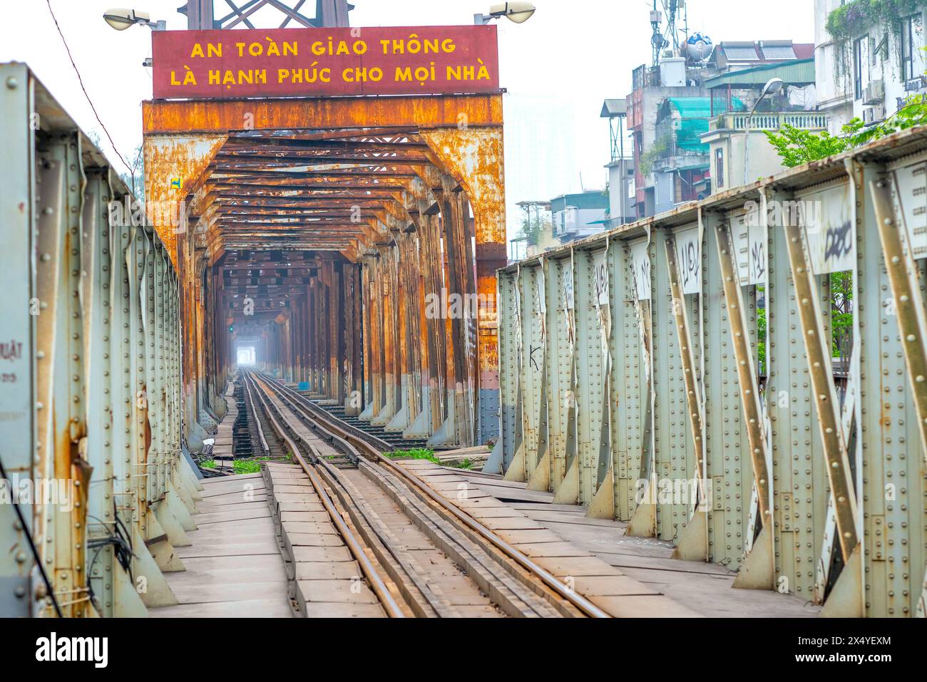 Vintage railroad tracks leading over the famous Long Bien Bridge. This ...