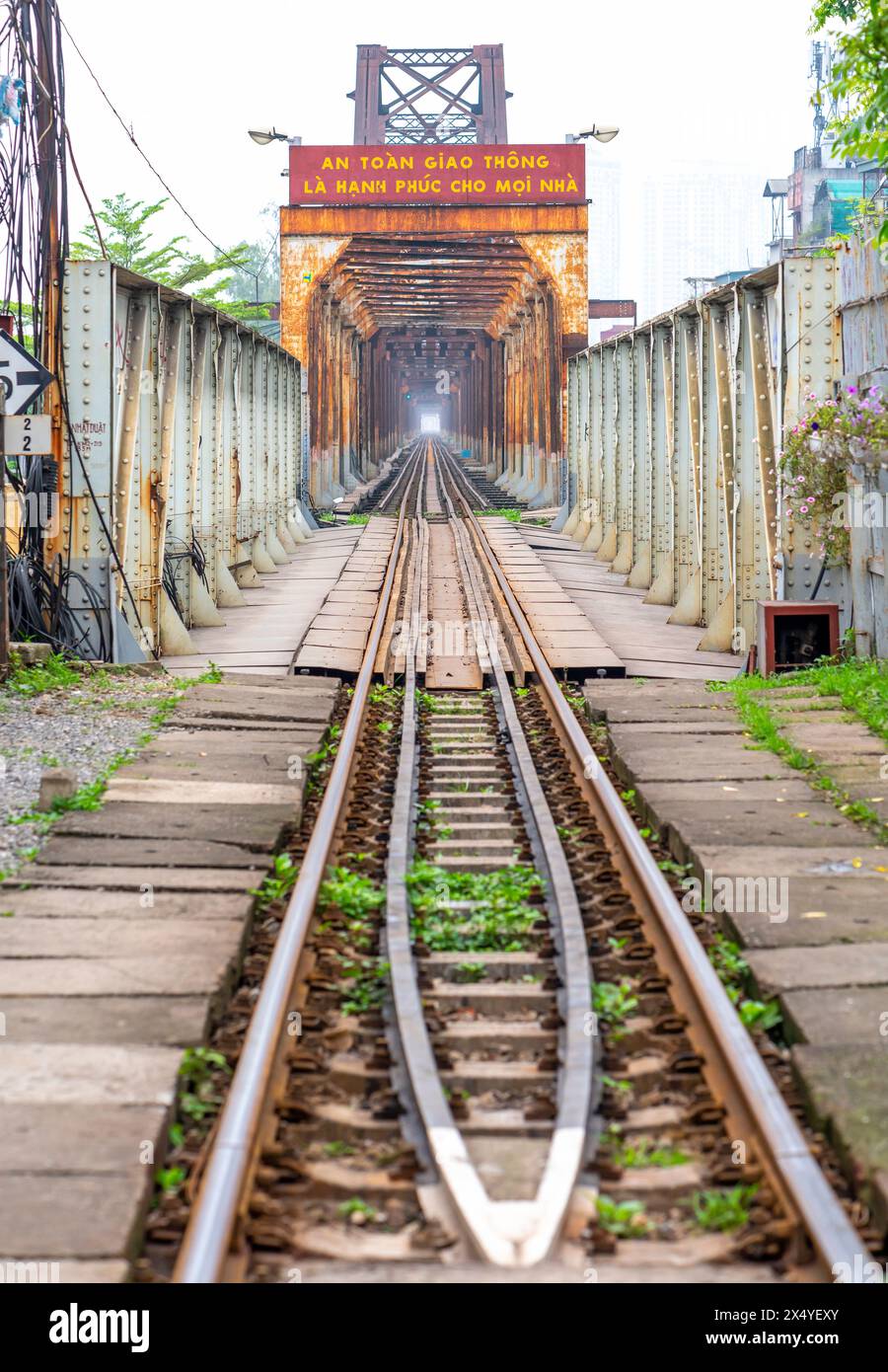 Vintage railroad tracks leading over the famous Long Bien Bridge. This ...